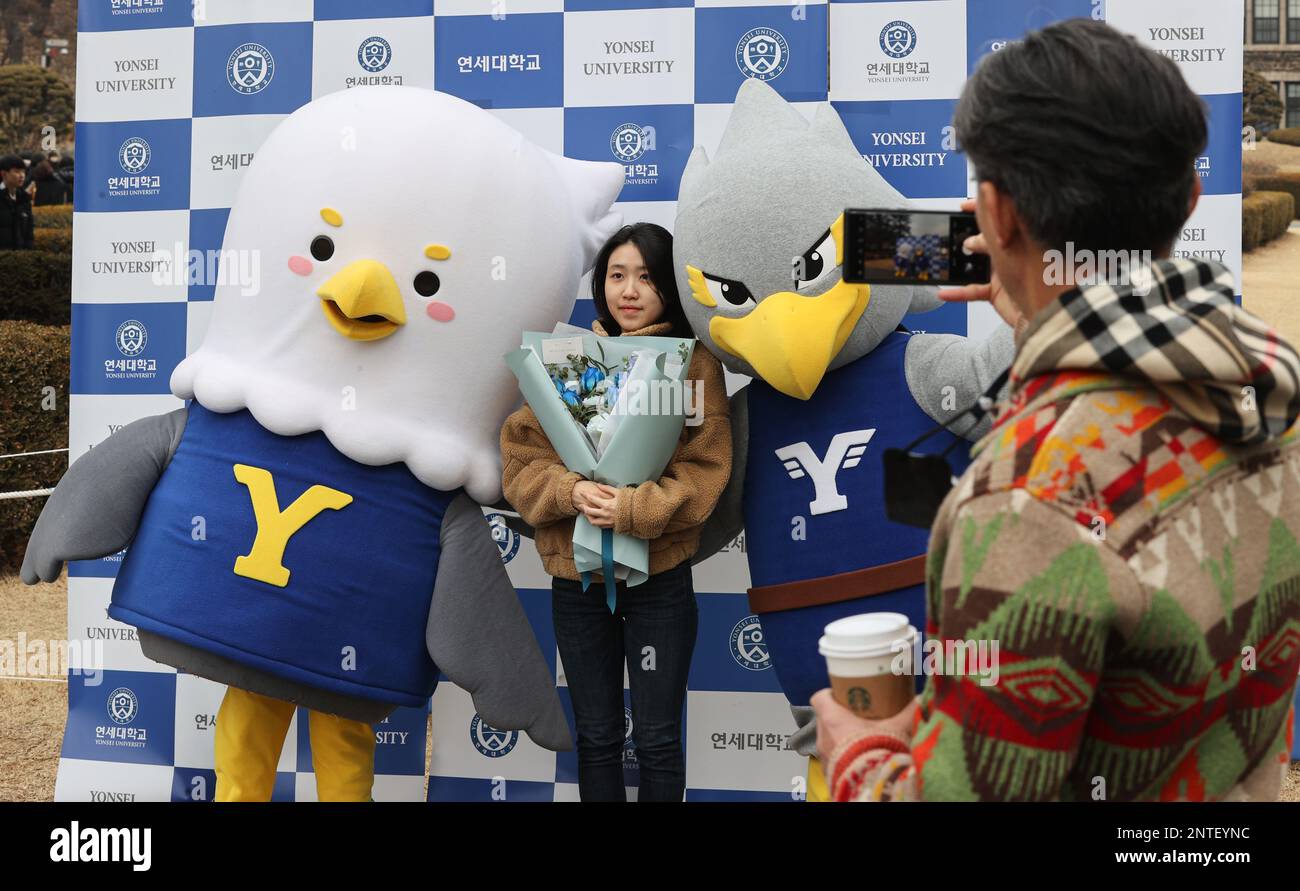 28th Feb, 2023. New entrants at university A freshman takes a photo with Eagle, the mascot of ...