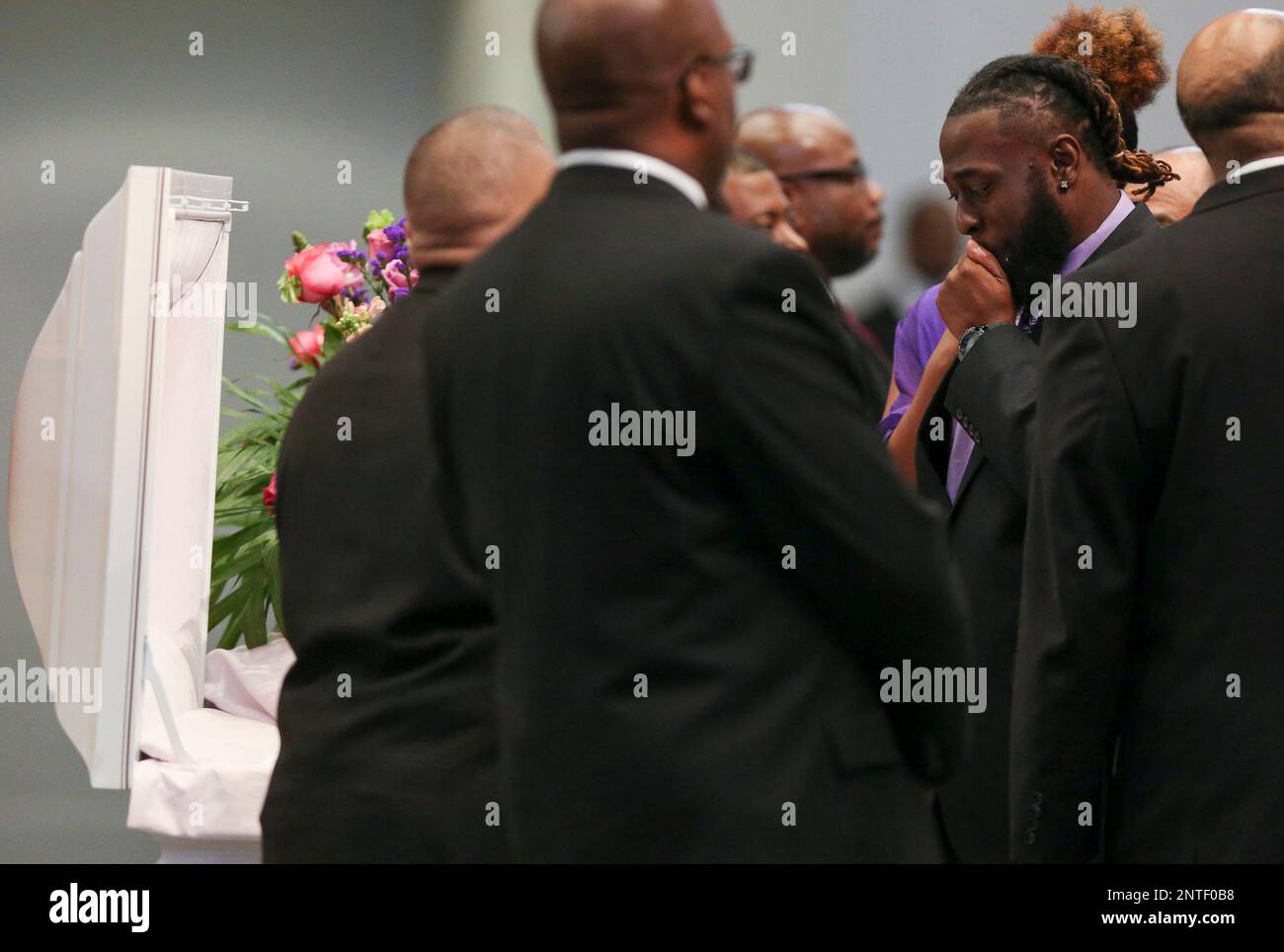 Cameron January, right, looks into the open casket of his mother ...