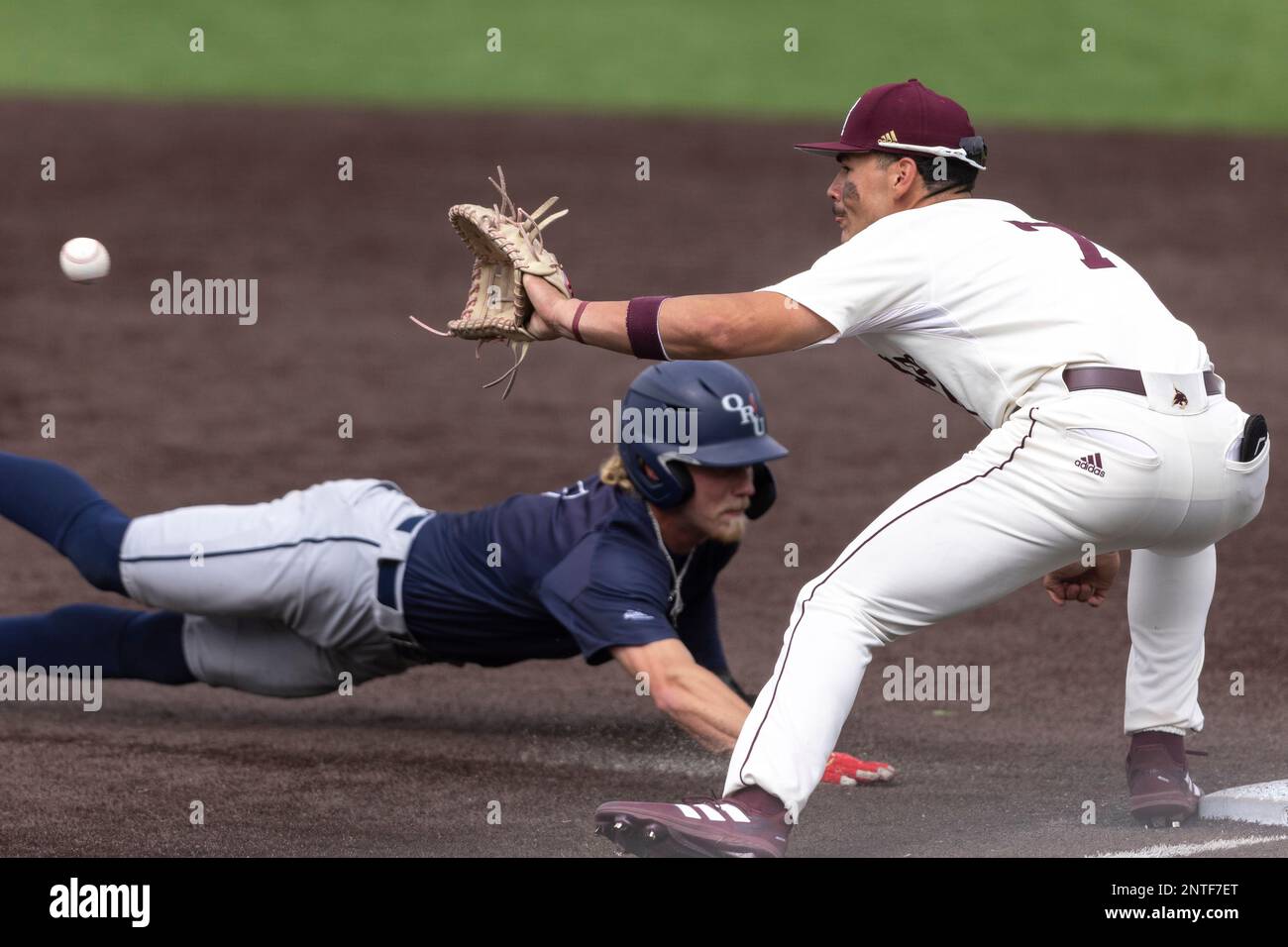 Oral Roberts center fielder Jonah Cox reaches for the tag as Texas ...
