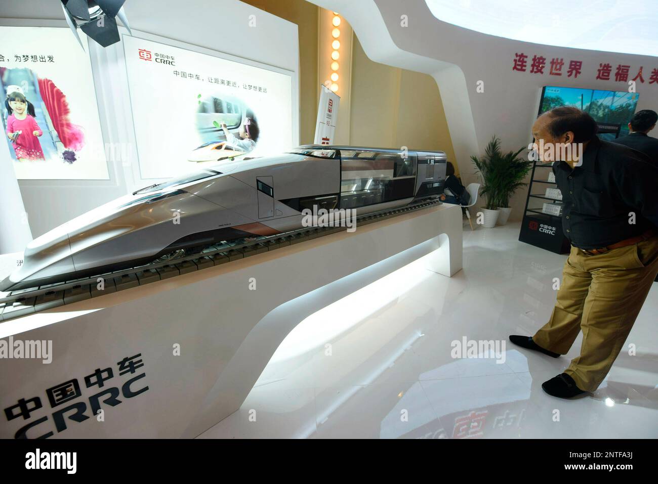 A visitor looks at a model of a concept inter-continental high-speed ...