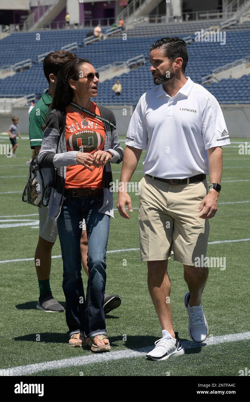 Miami head coach Manny Diaz, right, talks to his wife, Stephanie Diaz ...