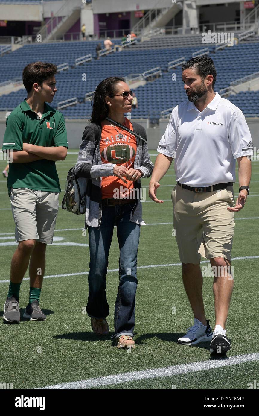 Miami head coach Manny Diaz, right, talks to his wife, Stephanie Diaz ...