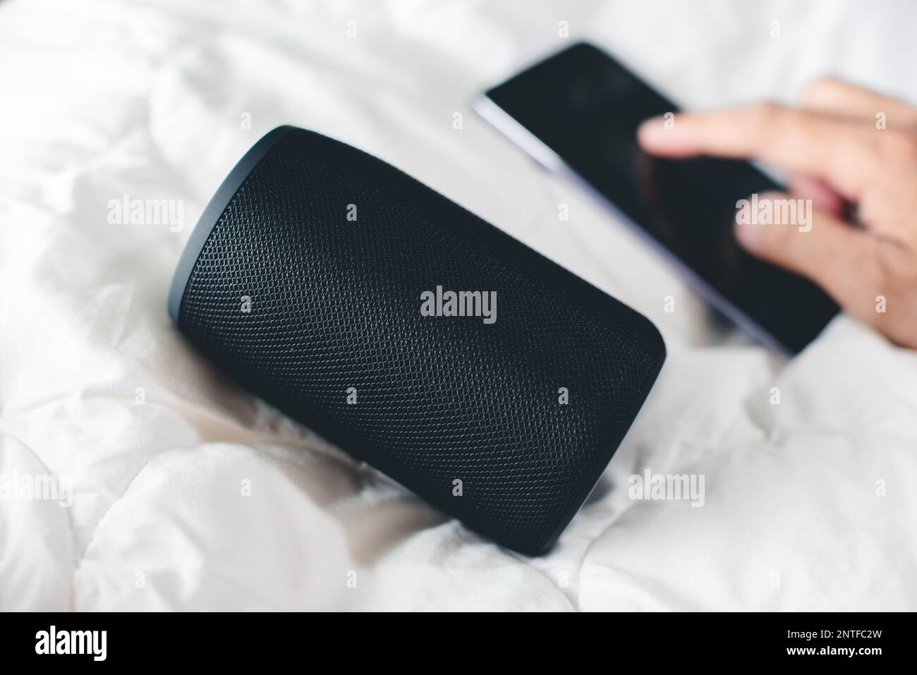 relaxing concept, Using wireless portable speaker on the bed Stock ...