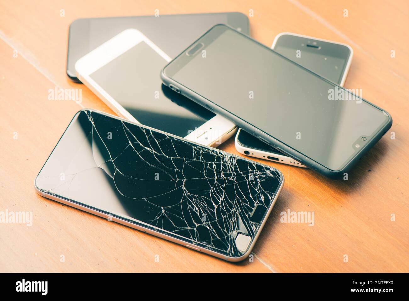 Heap of broken smart phone. Close up at smart phone with cracked screen ...
