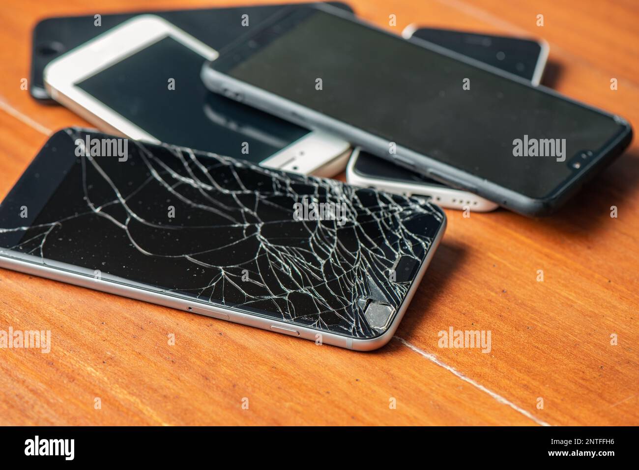 Heap of broken smart phone. Close up at smart phone with cracked screen ...