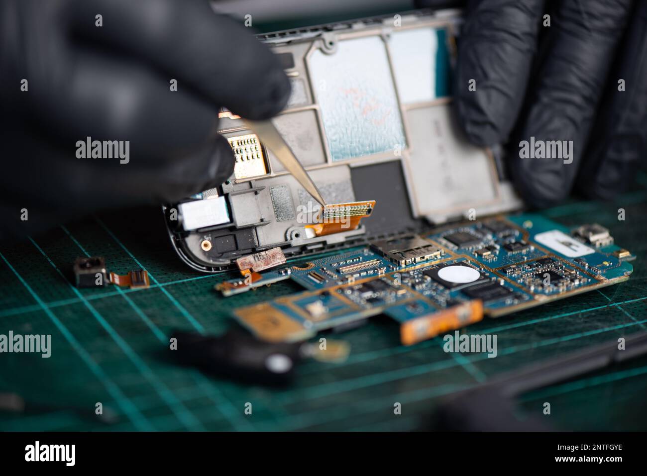 Technician reparing the broken smart phone. smart phone service Stock ...