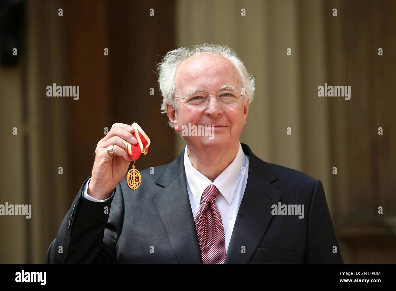 Author Philip Pullman with his knighthood following an investiture ...
