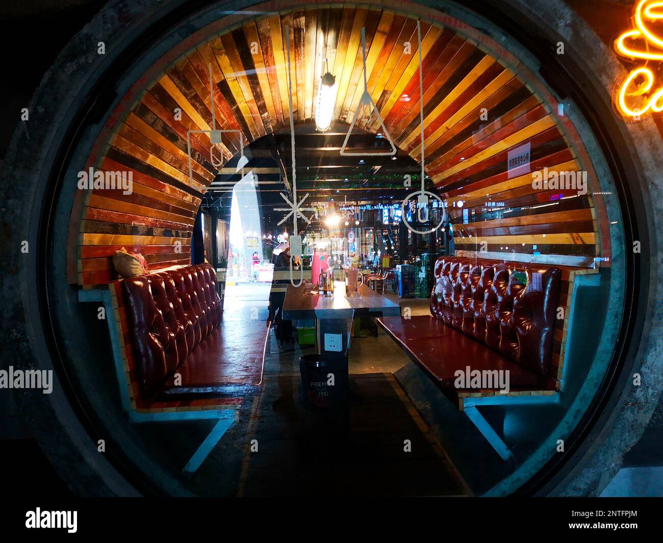 A view of a cafe featuring booths made in 2.2-meter-wide cement sewage ...