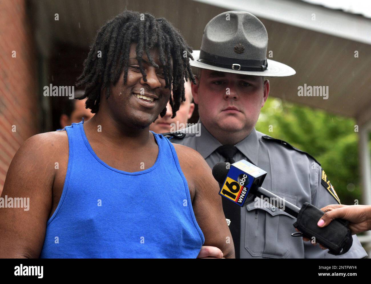 Homicide suspect Devin Malik Cunningham is escorted into district court ...