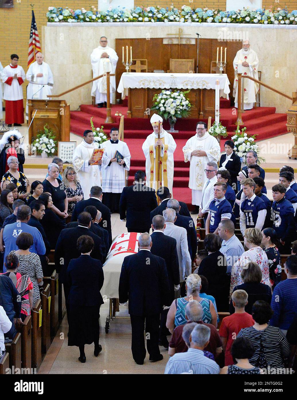 The casket of Monsignor Richard O'Keeffe, who died May 2, is escorted ...