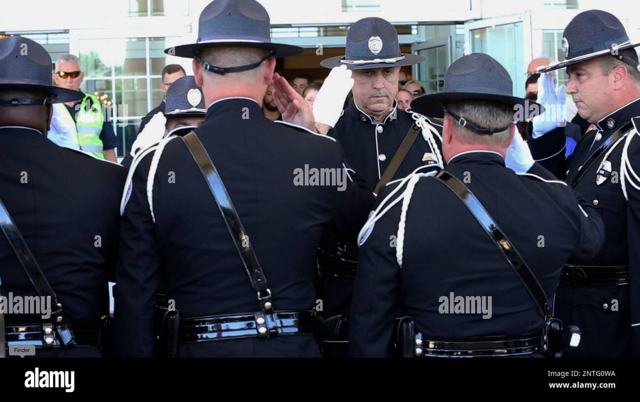 The Biloxi, Miss., Police Department Honor Guard salute after carrying ...