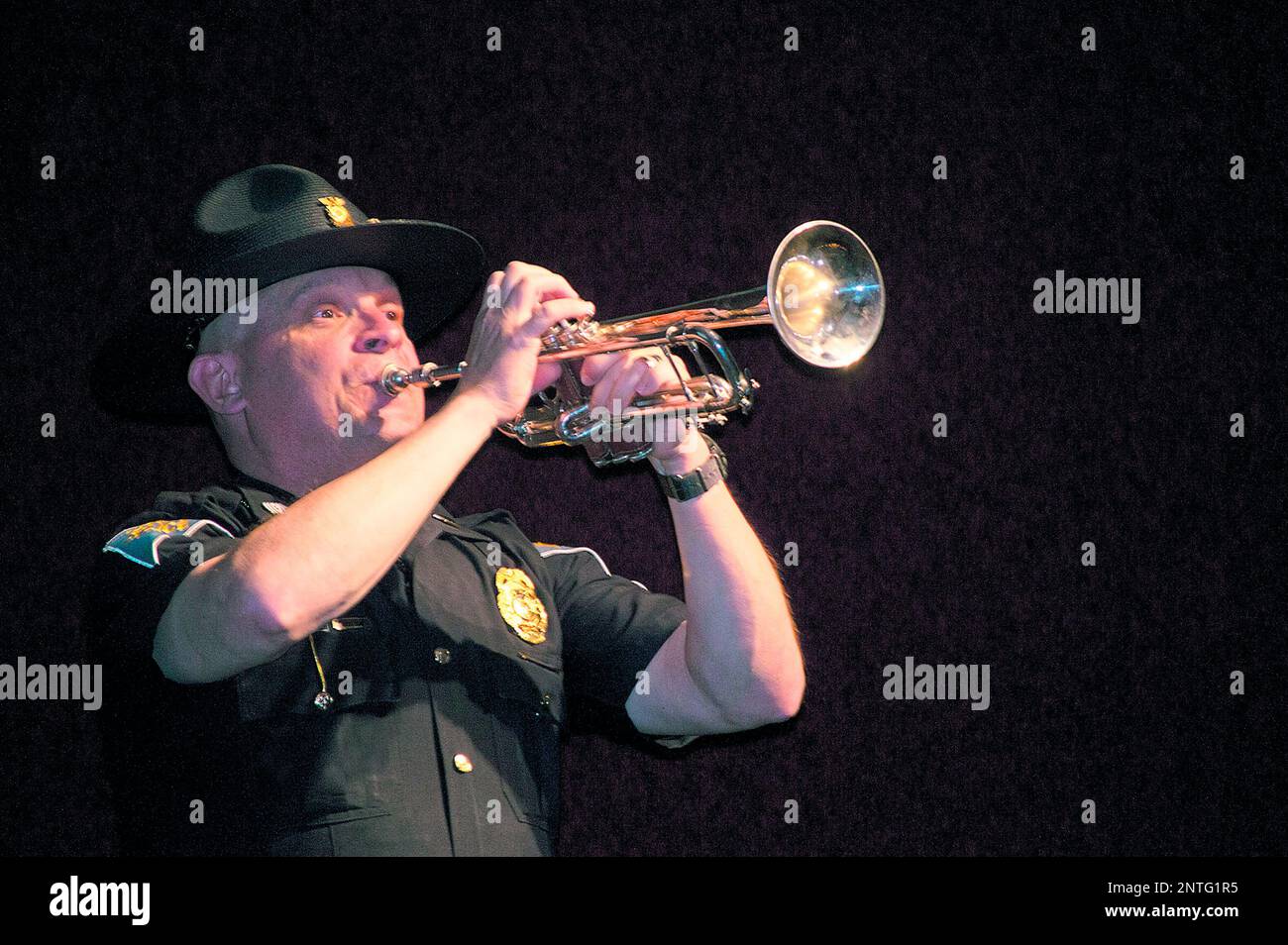 Sgt. Brian Schnick, of the Indiana State Police, performs taps ...