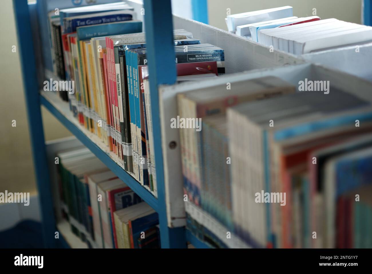 Various School Learning Books Are Arranged On Iron Shelves In The ...