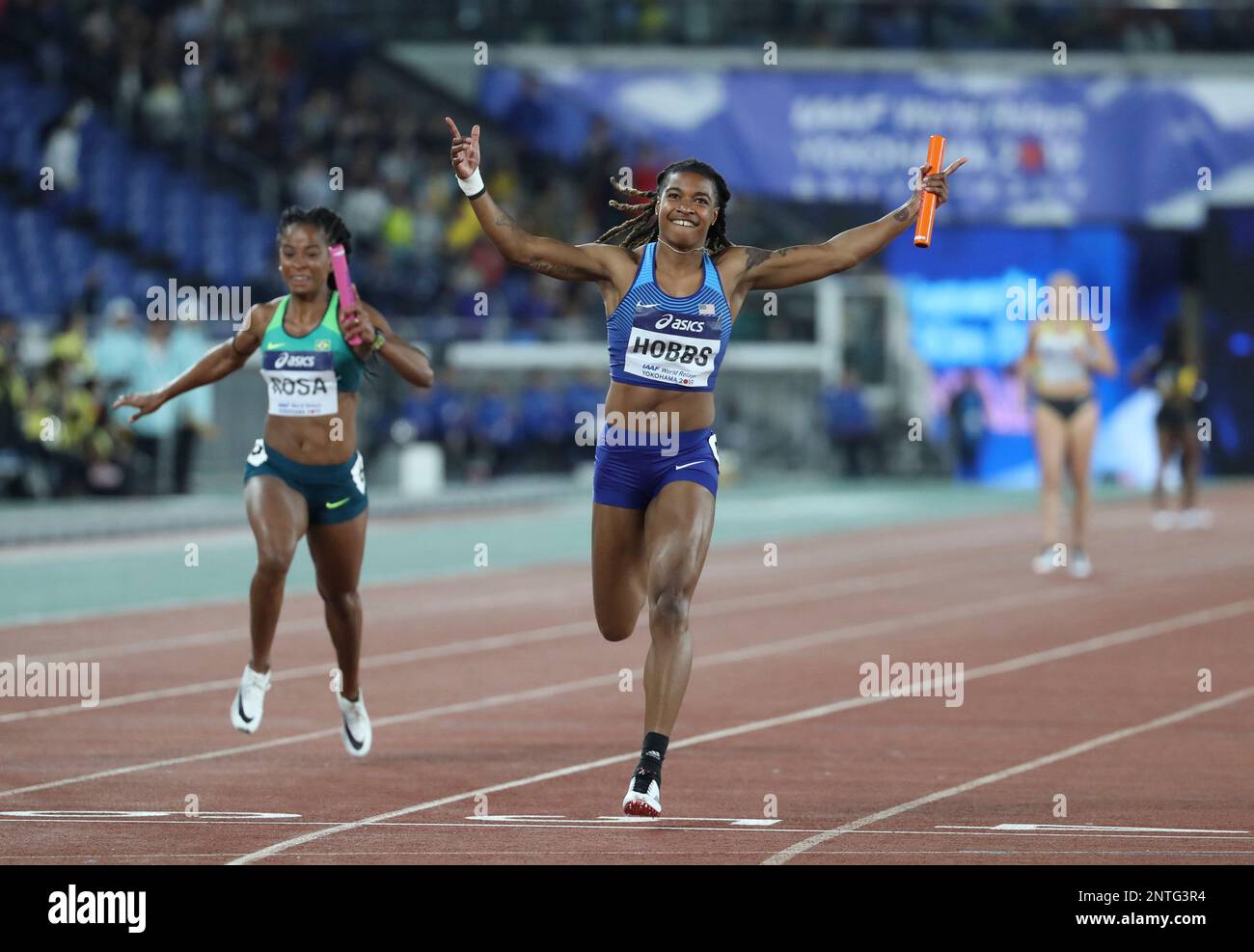 U.S. Aleia HOBBS (blue shirt) reacts as winning the 4x100 Metres Relay ...