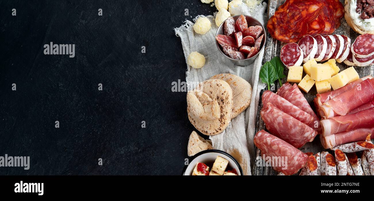Typical spanish tapas with jamon slices, chorizo, salami, olives ...
