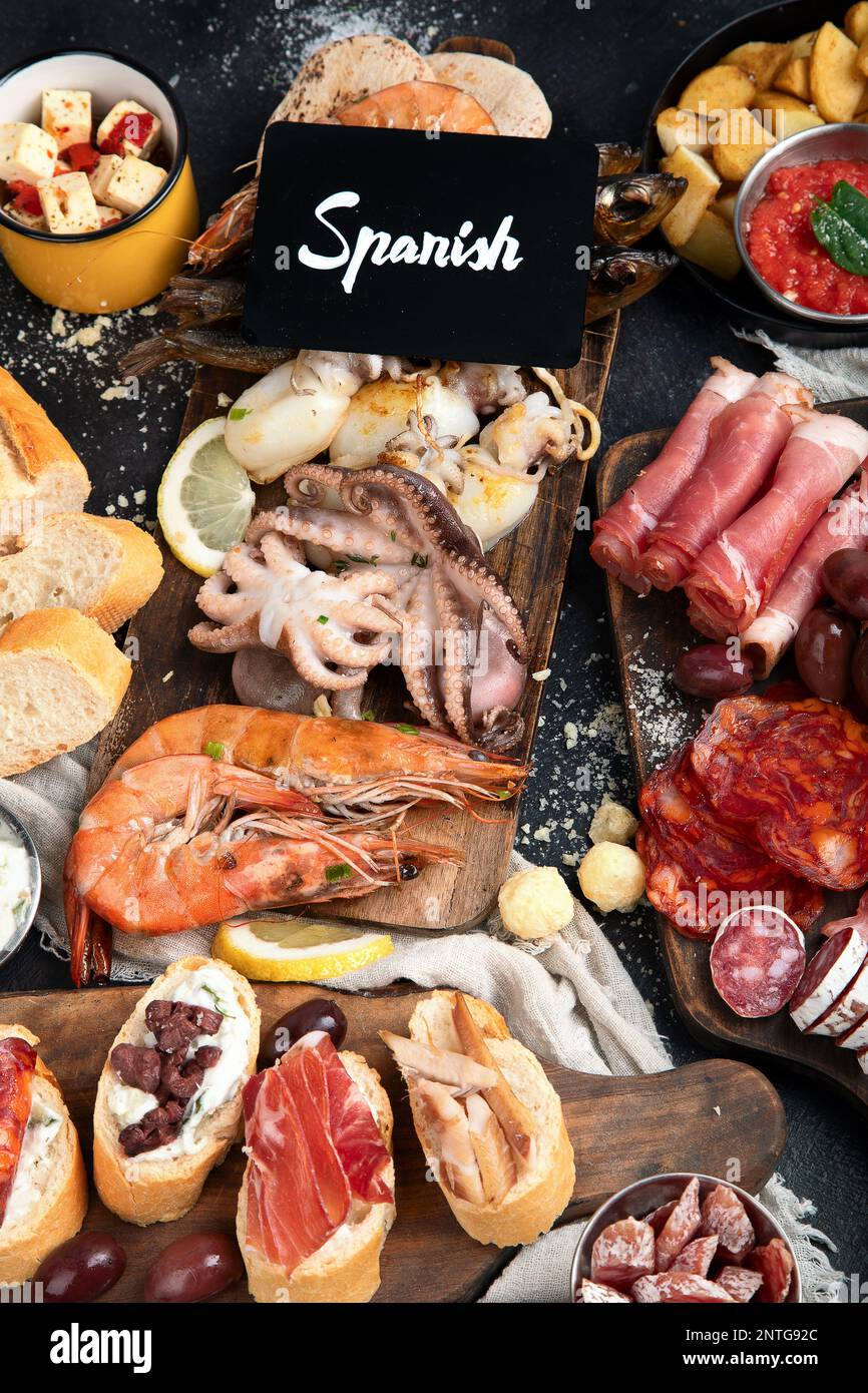 Typical spanish tapas with jamon slices, chorizo, salami, olives ...