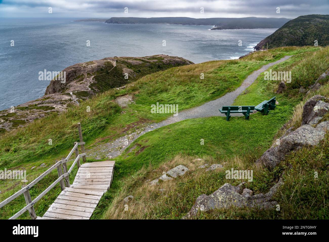 Hiking trail and wooden boardwalk and park benches overlooking the ...