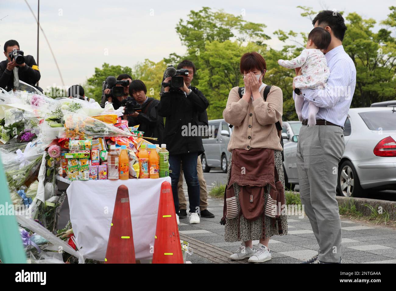 People offer a silent prayer for two kids victims killed by the minivehicle in front of a make ...