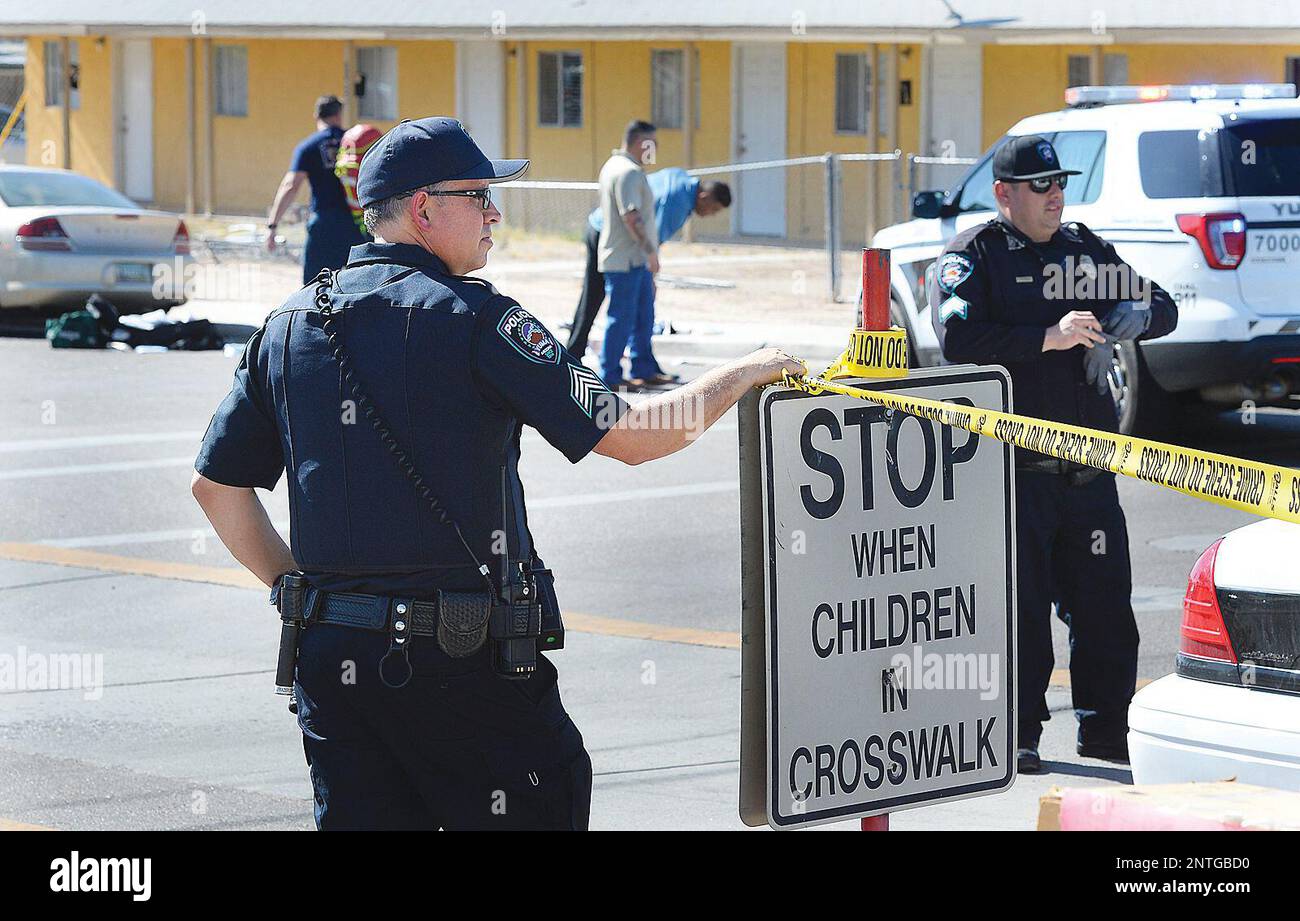 A Yuma Police Department sergeant prepares to stretch crime scene tape ...