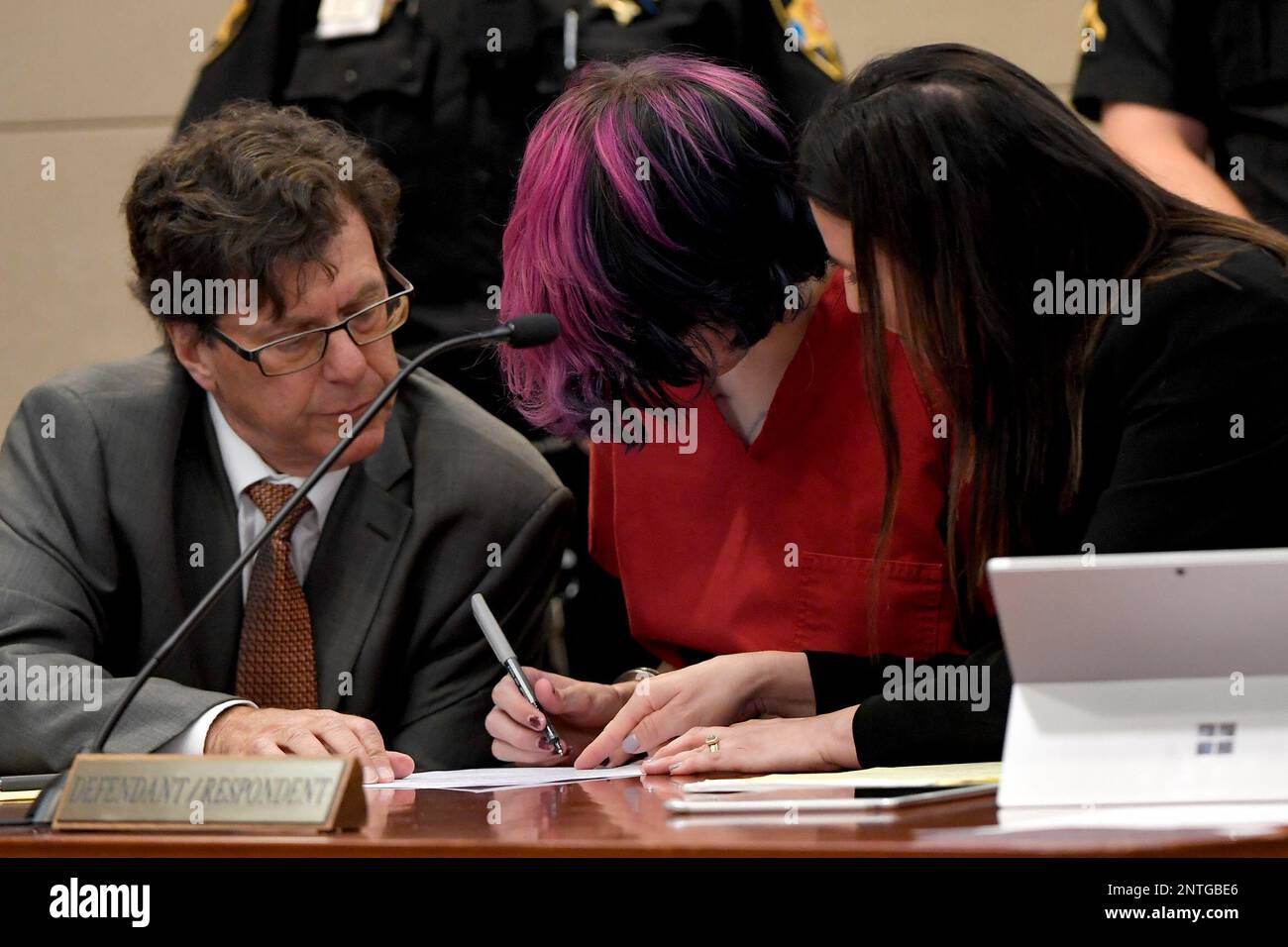 Devon Erickson, an accused STEM school shooter, signs paperwork during ...
