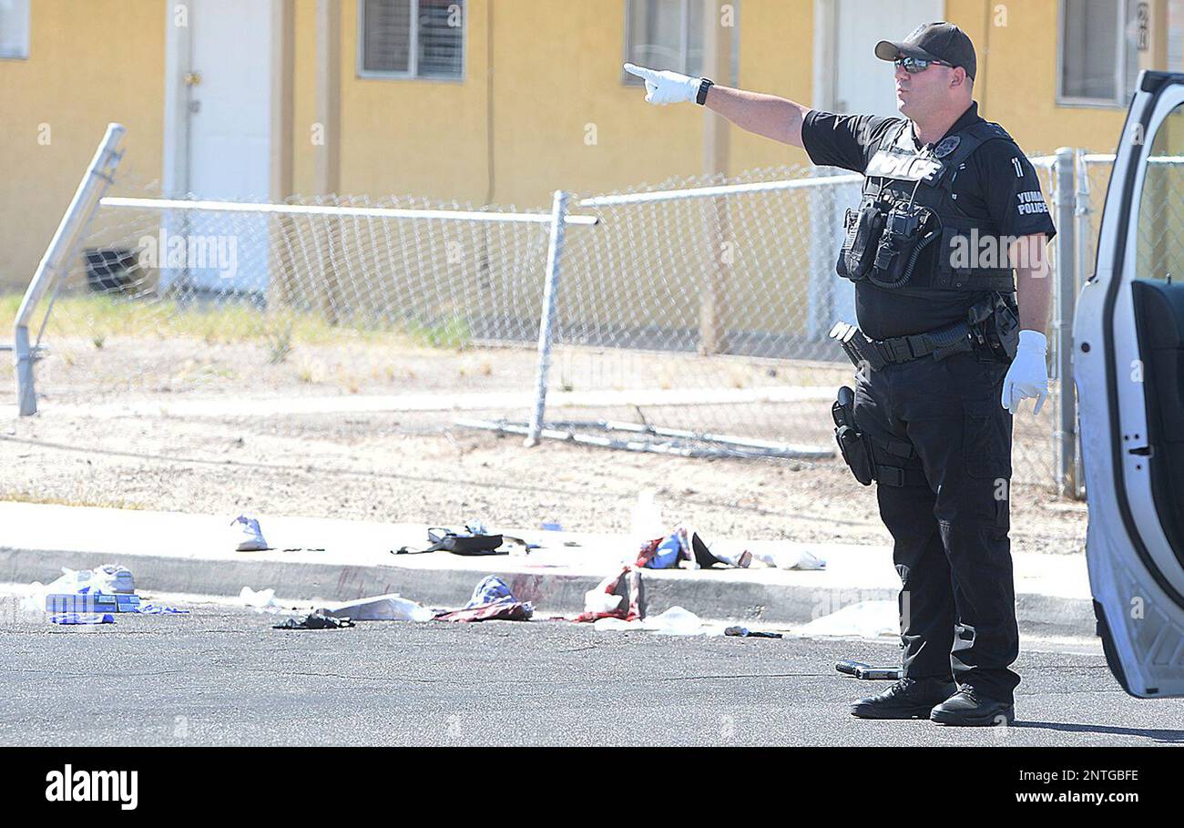 A Yuma Police Department officer works the scene of a shooting Friday ...