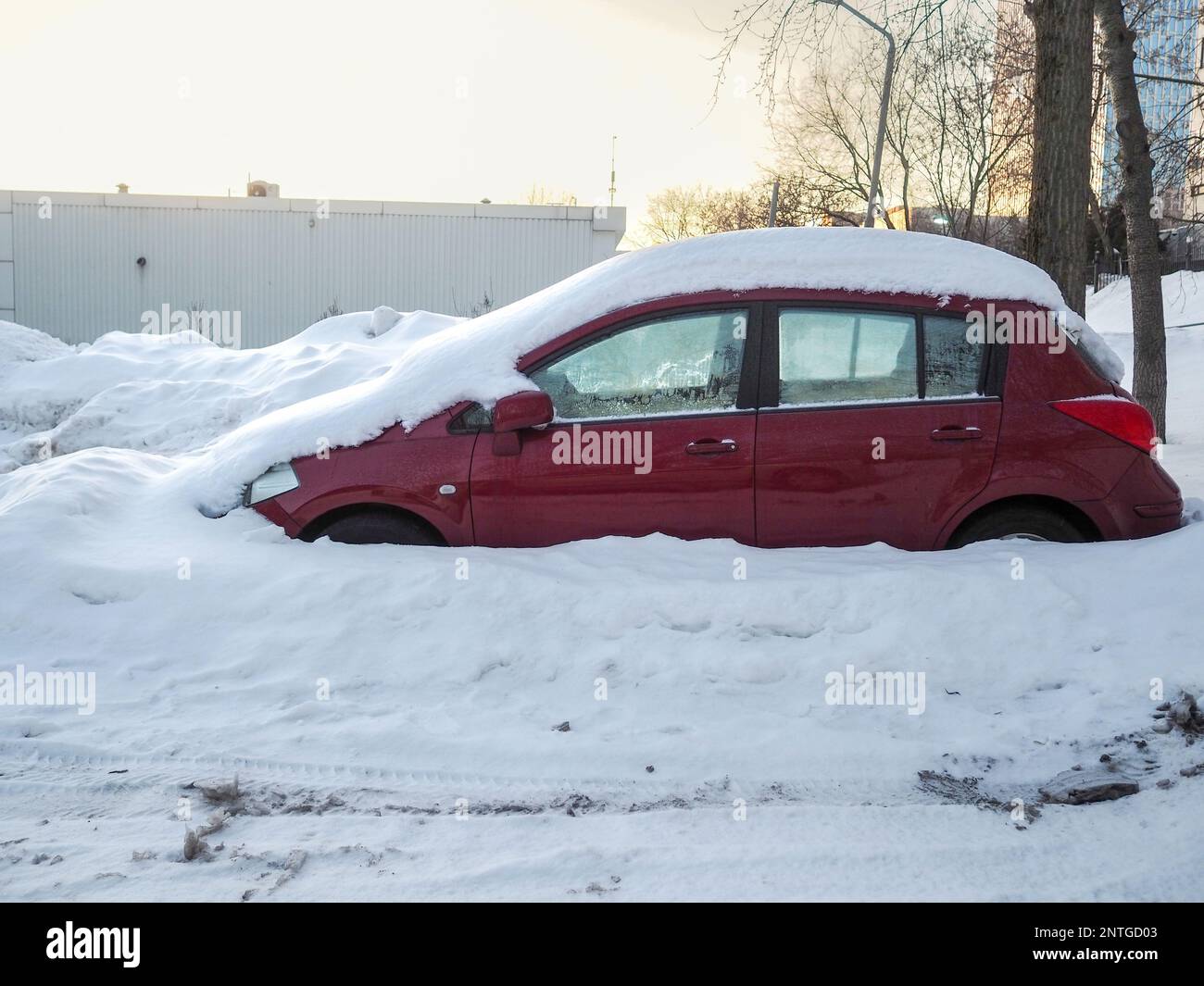 Moscow. Russia. February 28, 2023. A red Nissan Tiida car was frozen ...
