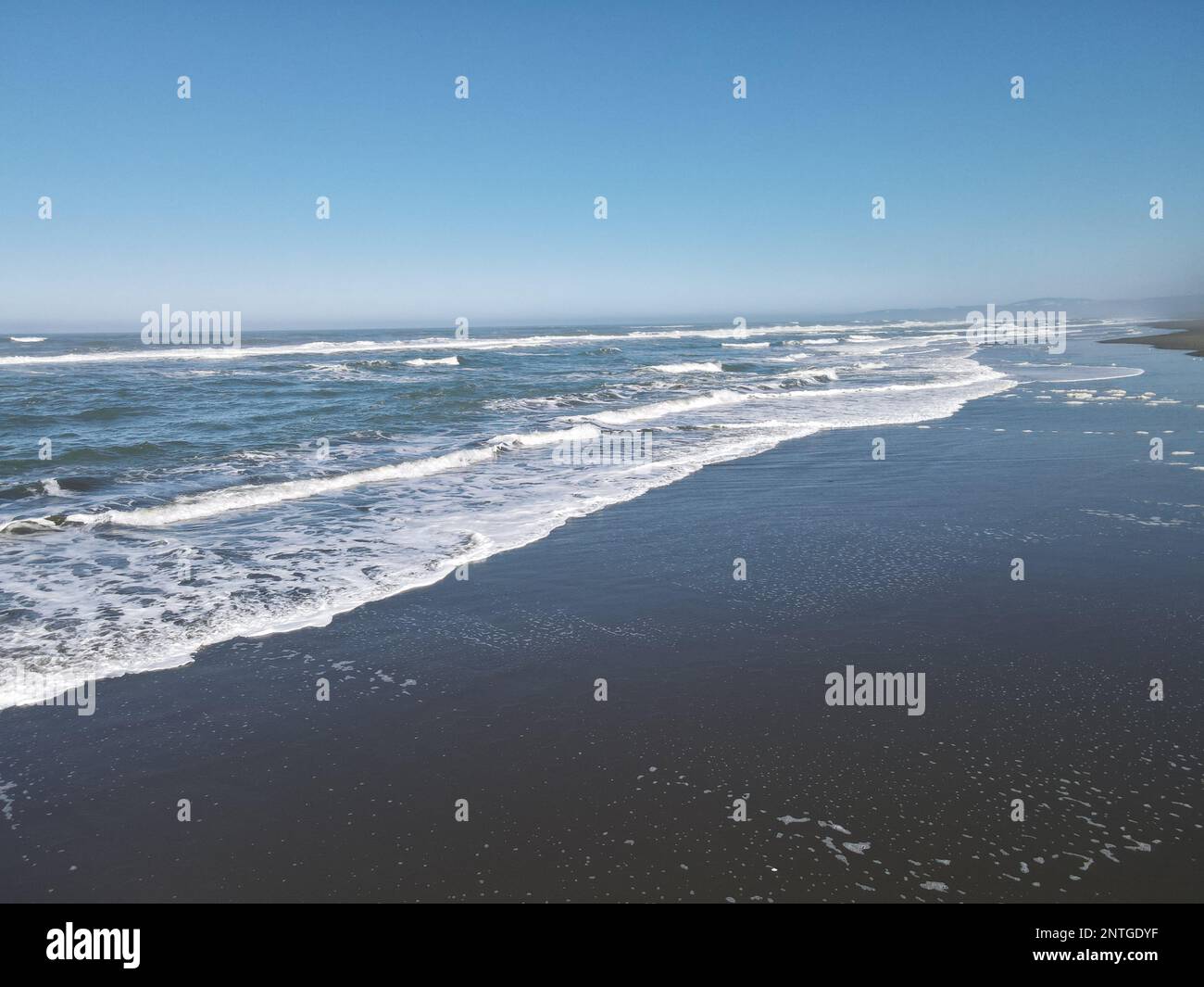 waves rolling along the beach Stock Photo - Alamy