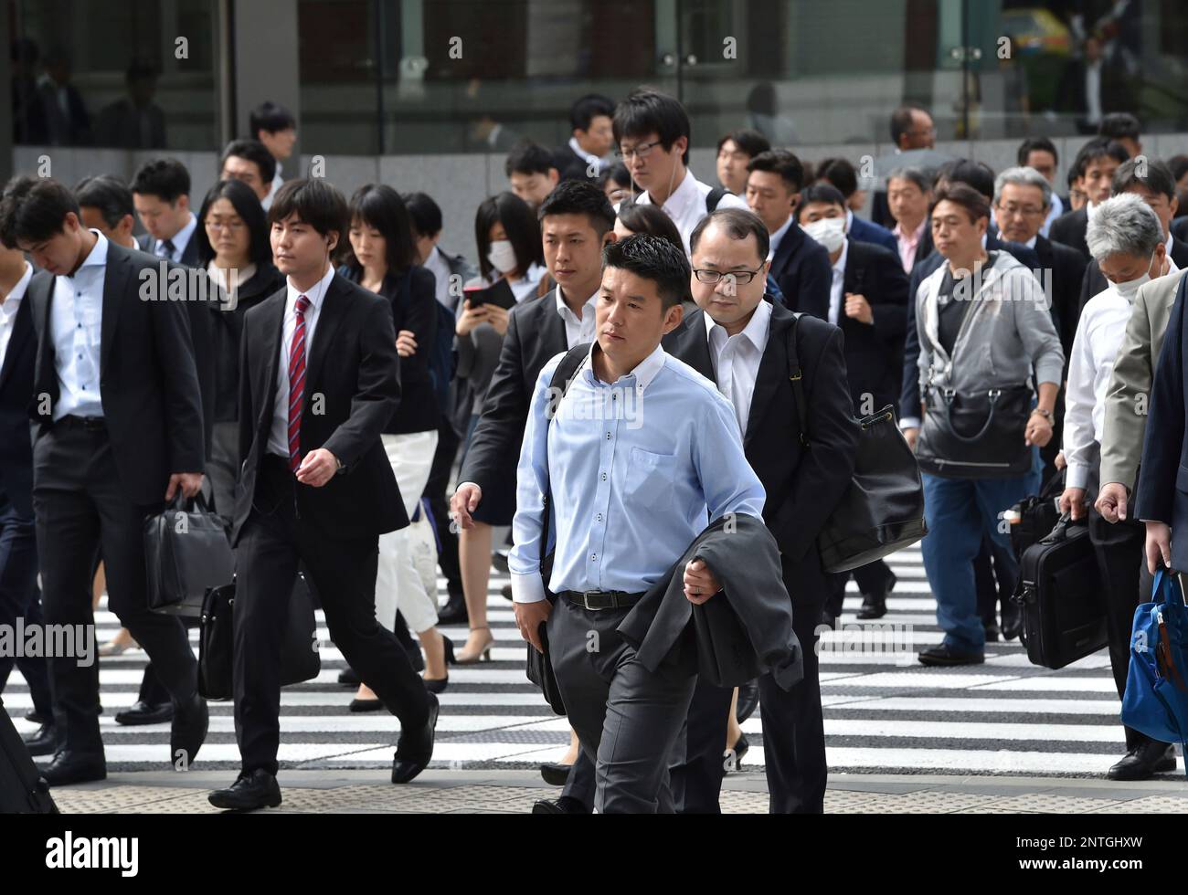 Workers head for their office in front of Tokyo station in Tokyo on May ...