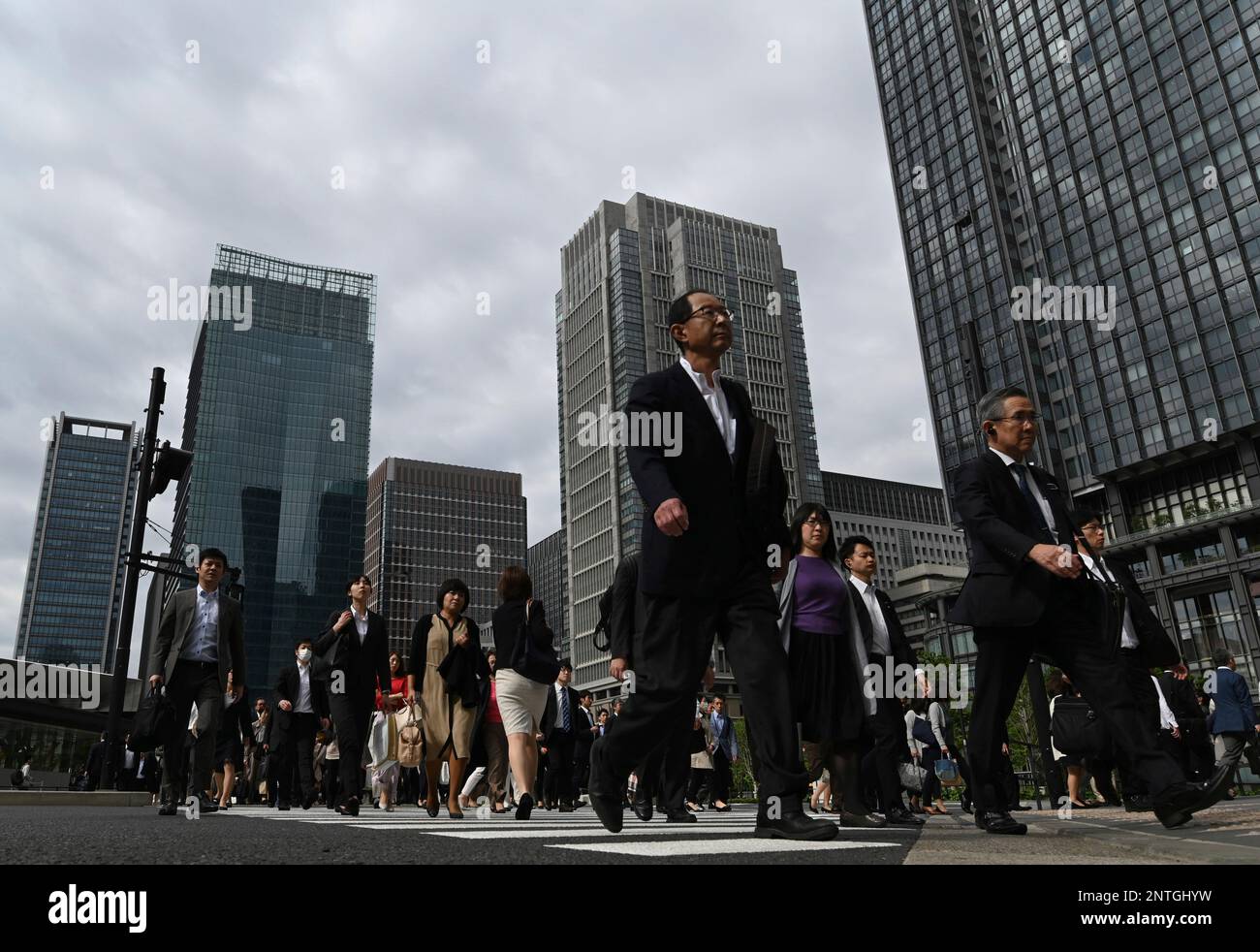 Workers head for their office in front of Tokyo station in Tokyo on May ...