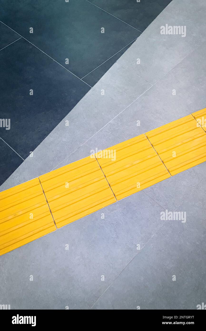 Footpath or yellow tactile tiles for the blind, top view, copy space ...