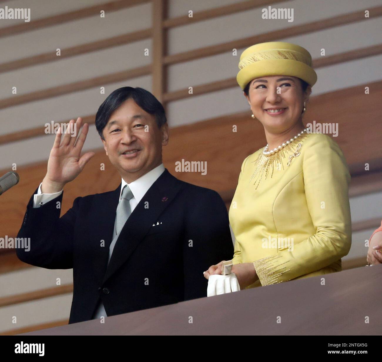 Japan's new Emperor Naruhito waves his hand with Empress Masako during ...