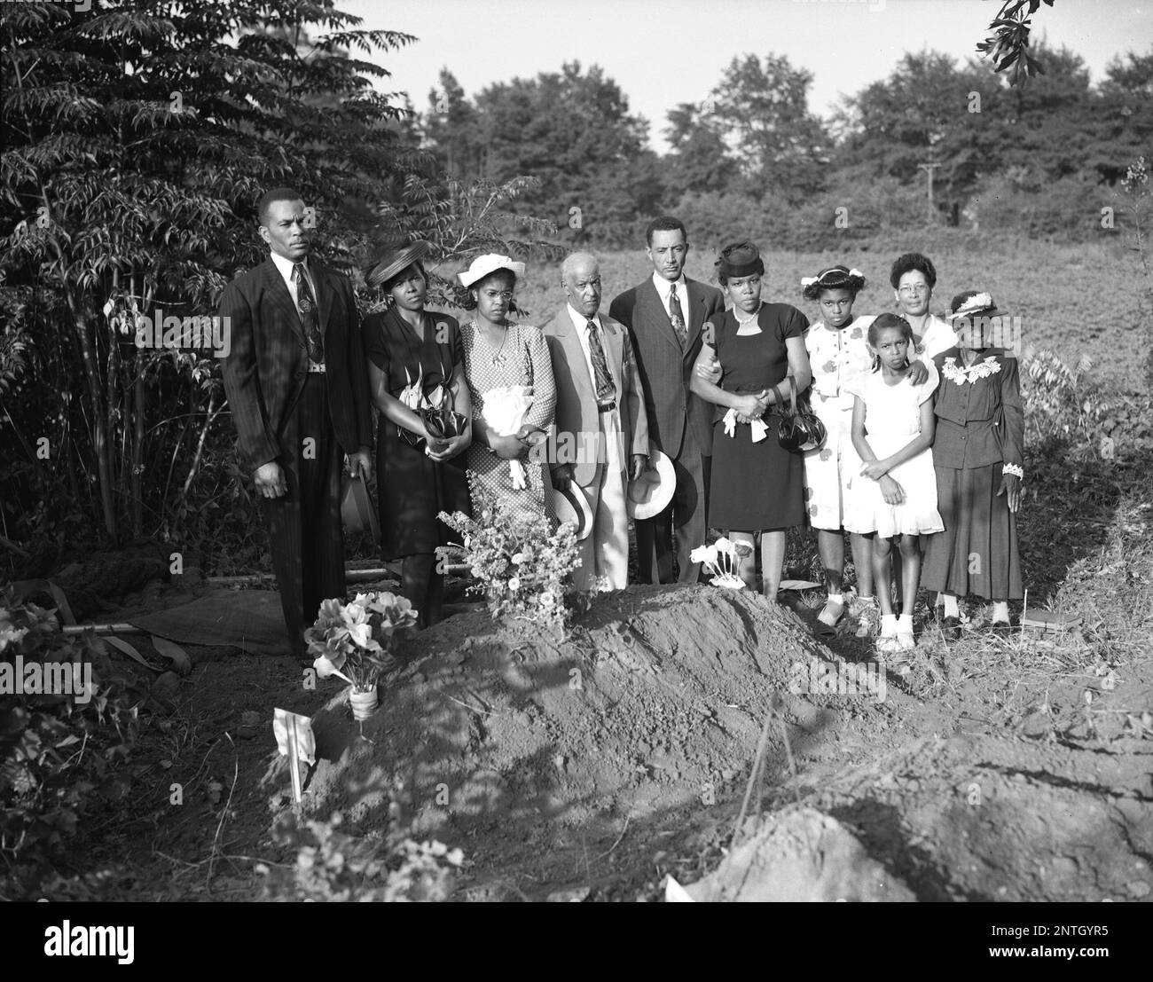 Graveside group portrait taken on July 28, 1946, following the burial ...