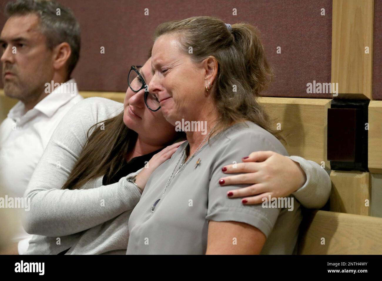 Debbi Hixon, right, the widow of victim Chris Hixon is consoled in ...