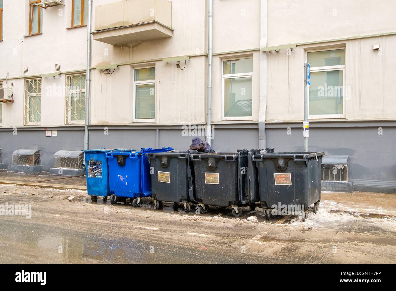Homeless rummaging through a garbage can hi-res stock photography and ...