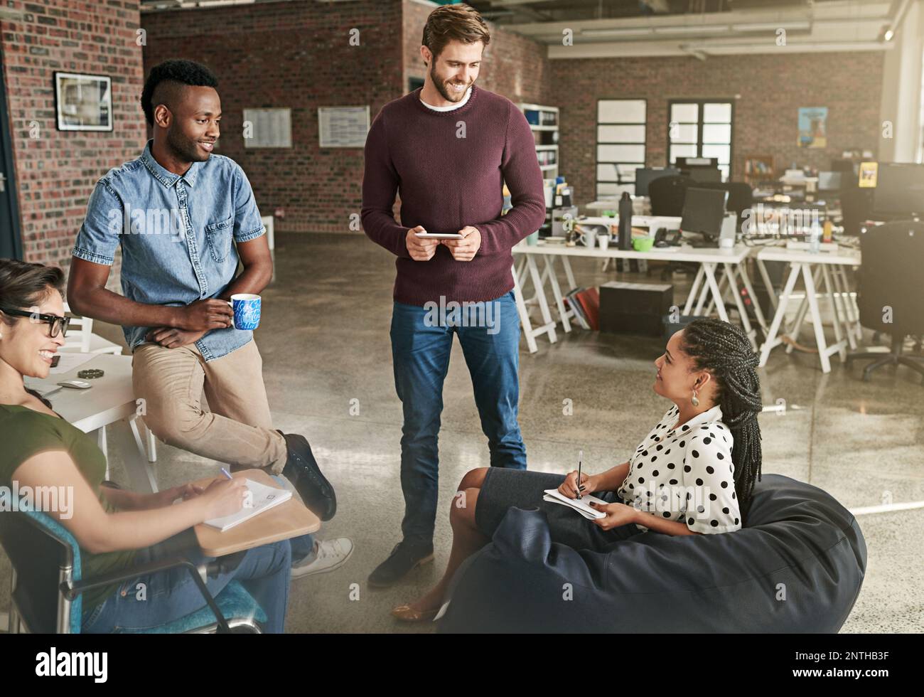 Taking an informal approach to their meetings. a team of colleagues ...