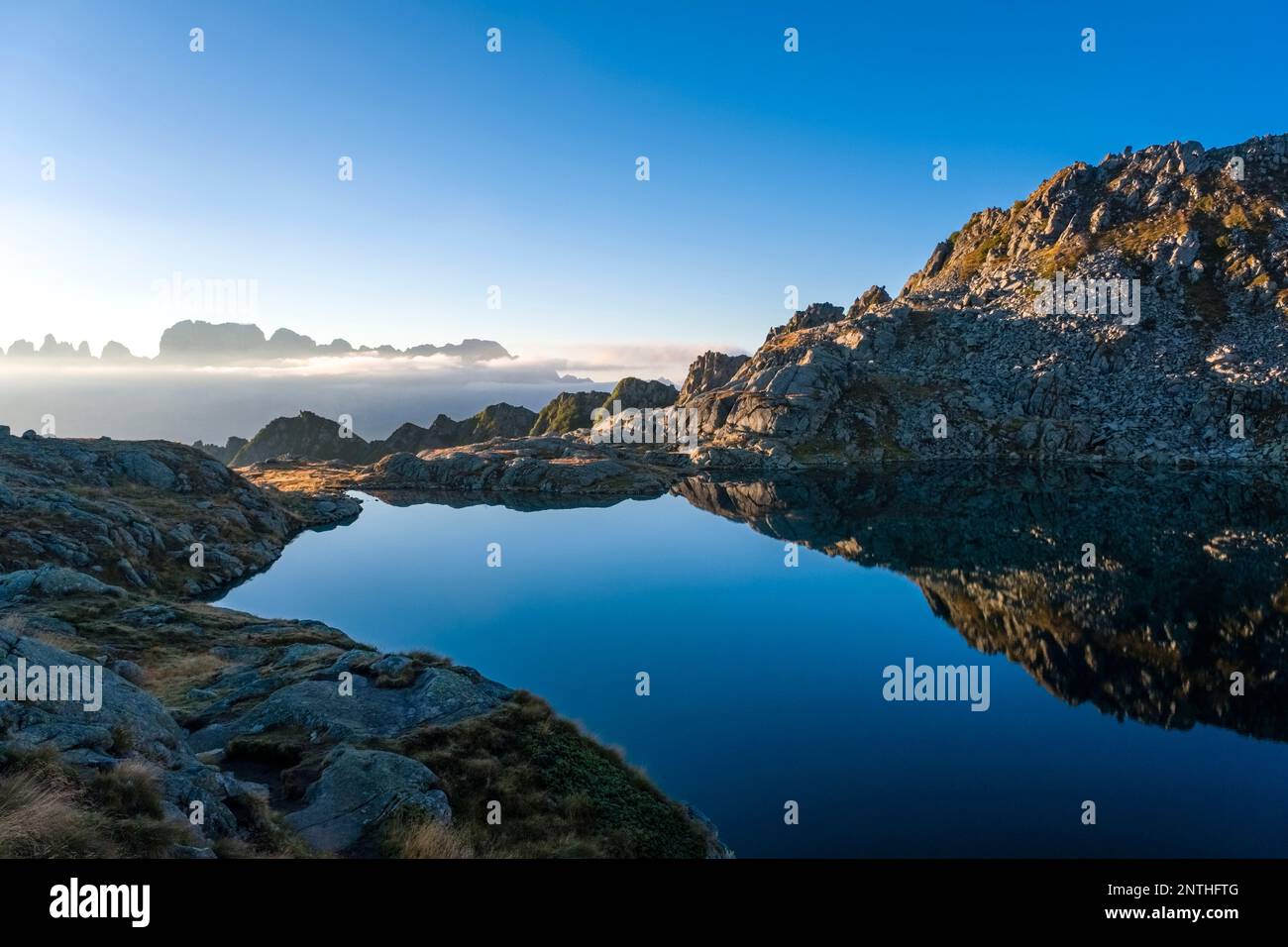 The lake Lago Nero, located on a high plateau, surrounded by rocks and ...