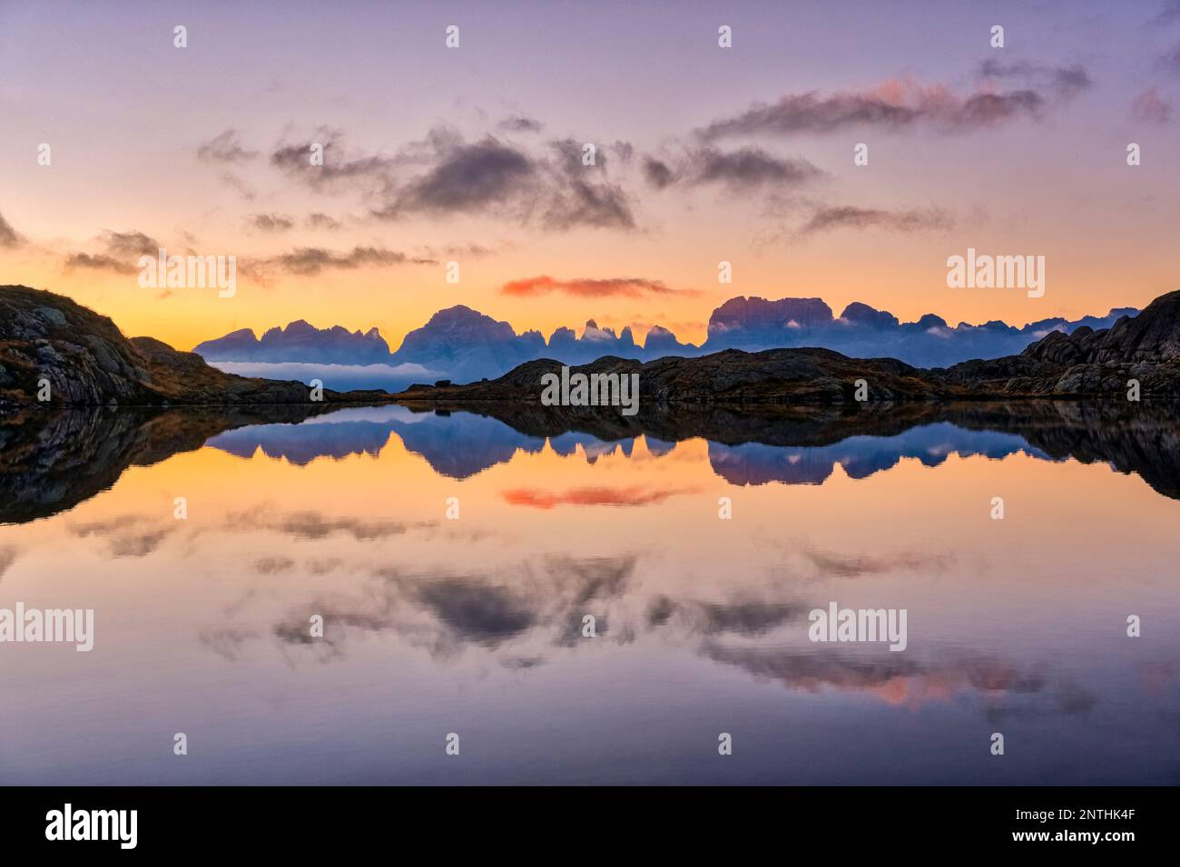 The main range of Brenta Dolomites, partially shrouded in colorfully ...