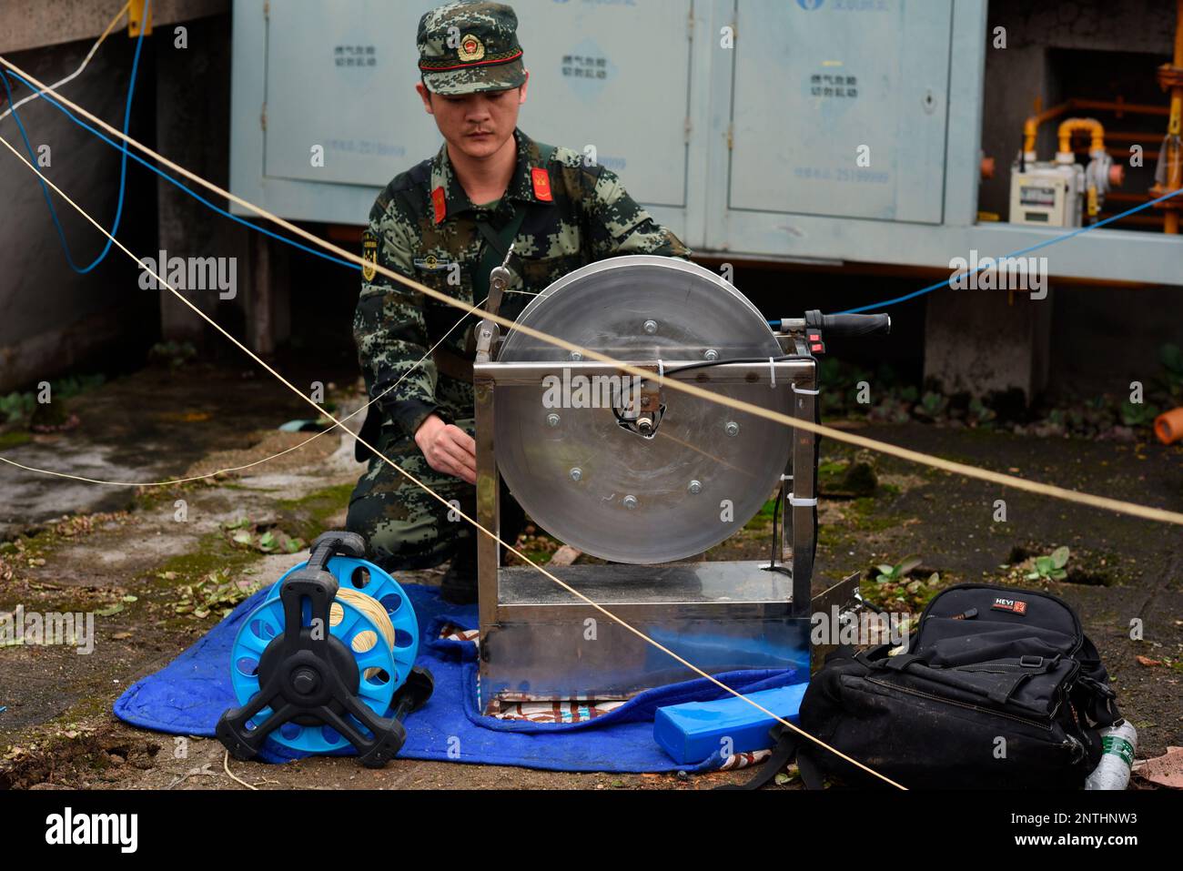 A paramilitary policeman dismantles the pulley line used by smugglers ...