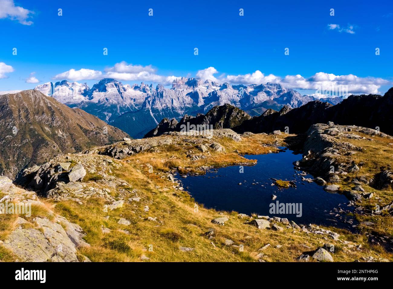 The main range of Brenta Dolomites, rising behind a small lake near ...