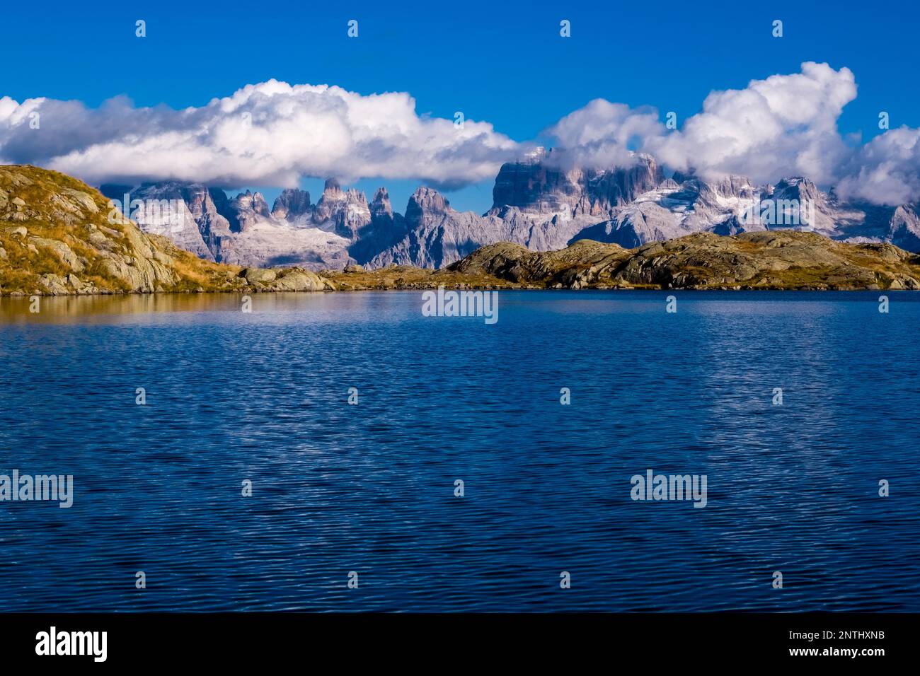 The main range of Brenta Dolomites, rising behind the lake Lago Nero ...