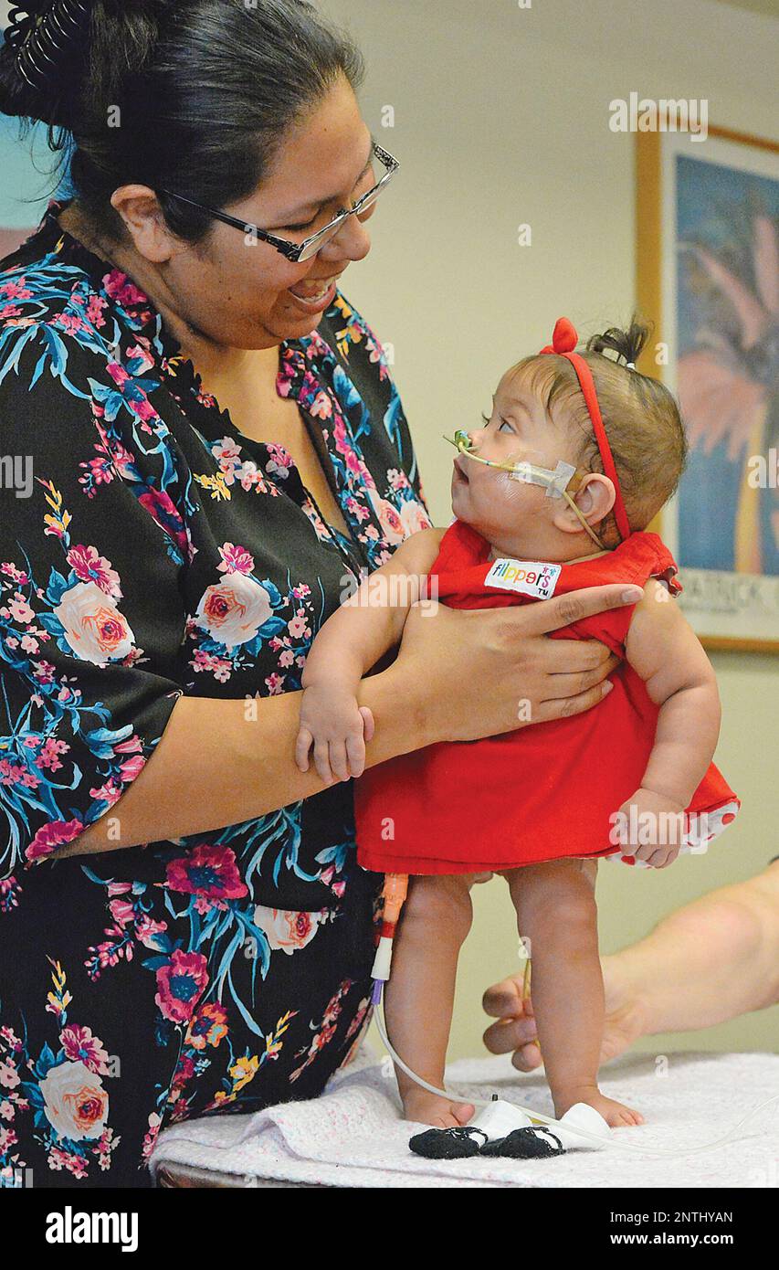 Tara Rivera, left, interacts with her nine-month-old daughter Alice ...