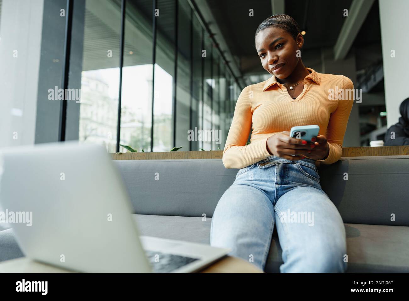African female student working on computer in public place Stock Photo ...