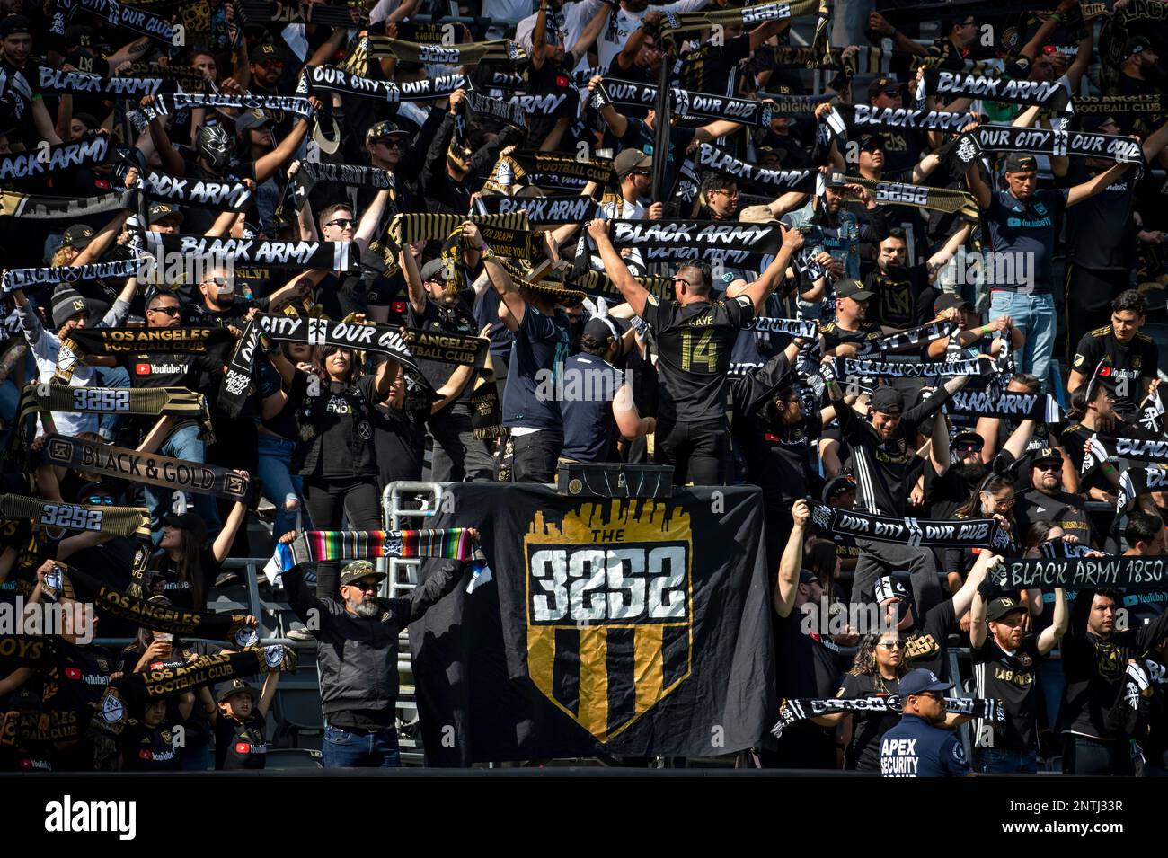 LAFC fans in the 3252 section hold scarves before a MLS soccer match ...