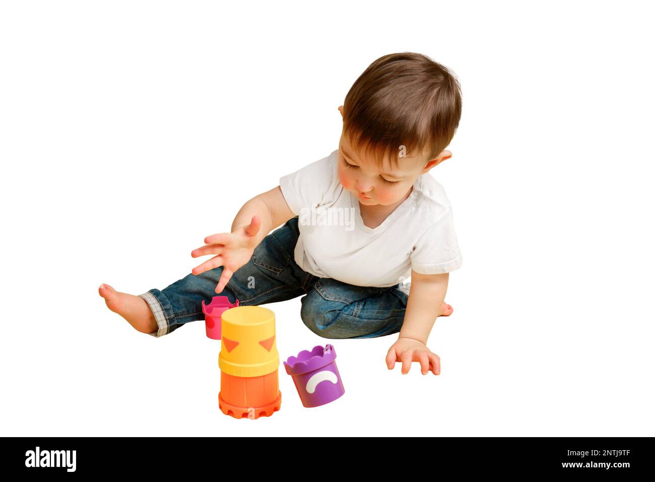 Toddler baby is playing logical educational games with a sandbox mold ...