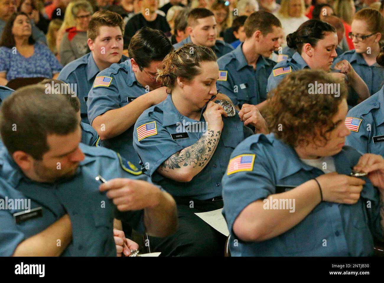 In this March 29, 2019 photo, Correctional officer trainees pin on ...