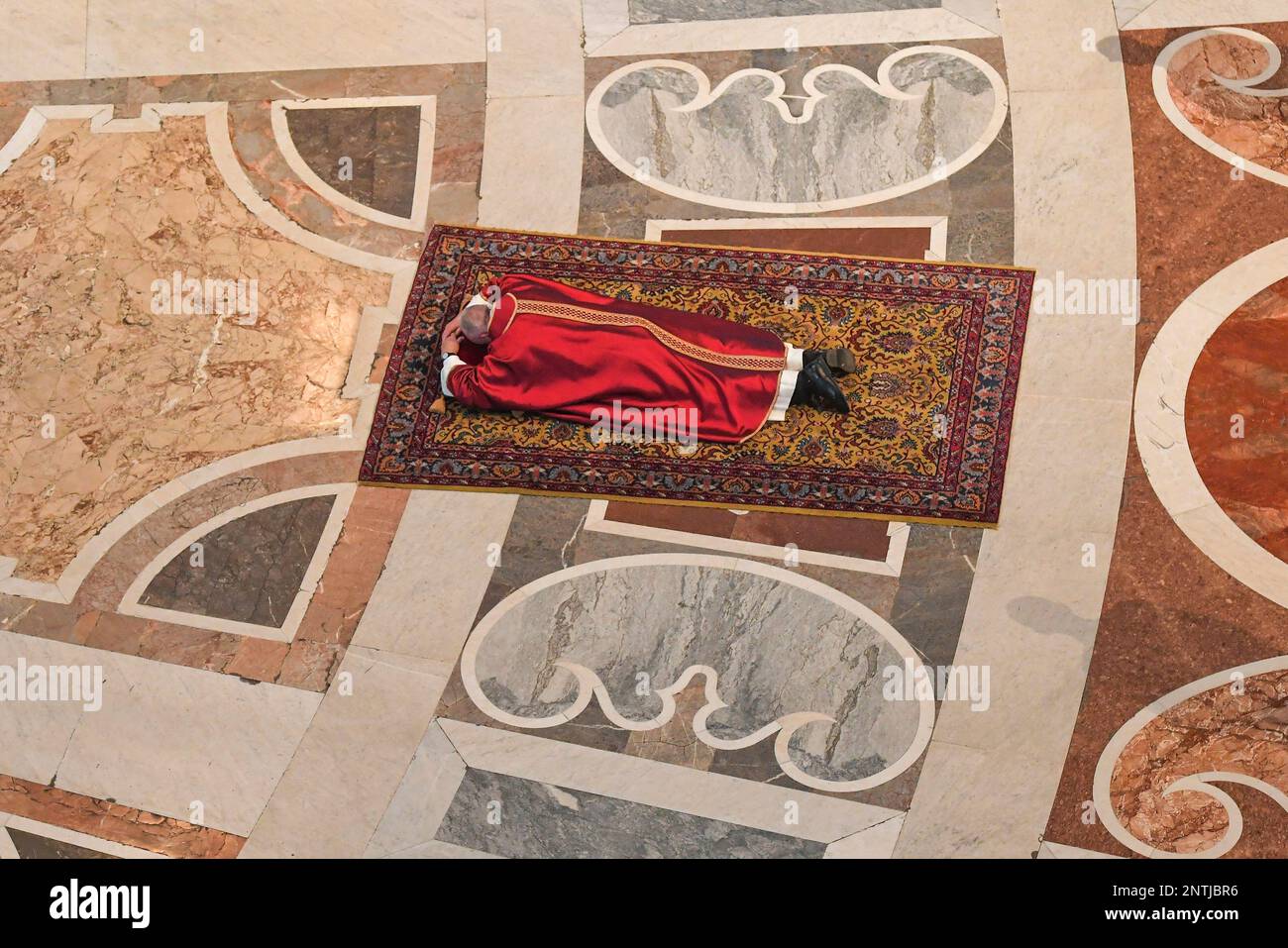 Pope Francis lies down in prayer prior to celebrate Mass for the ...