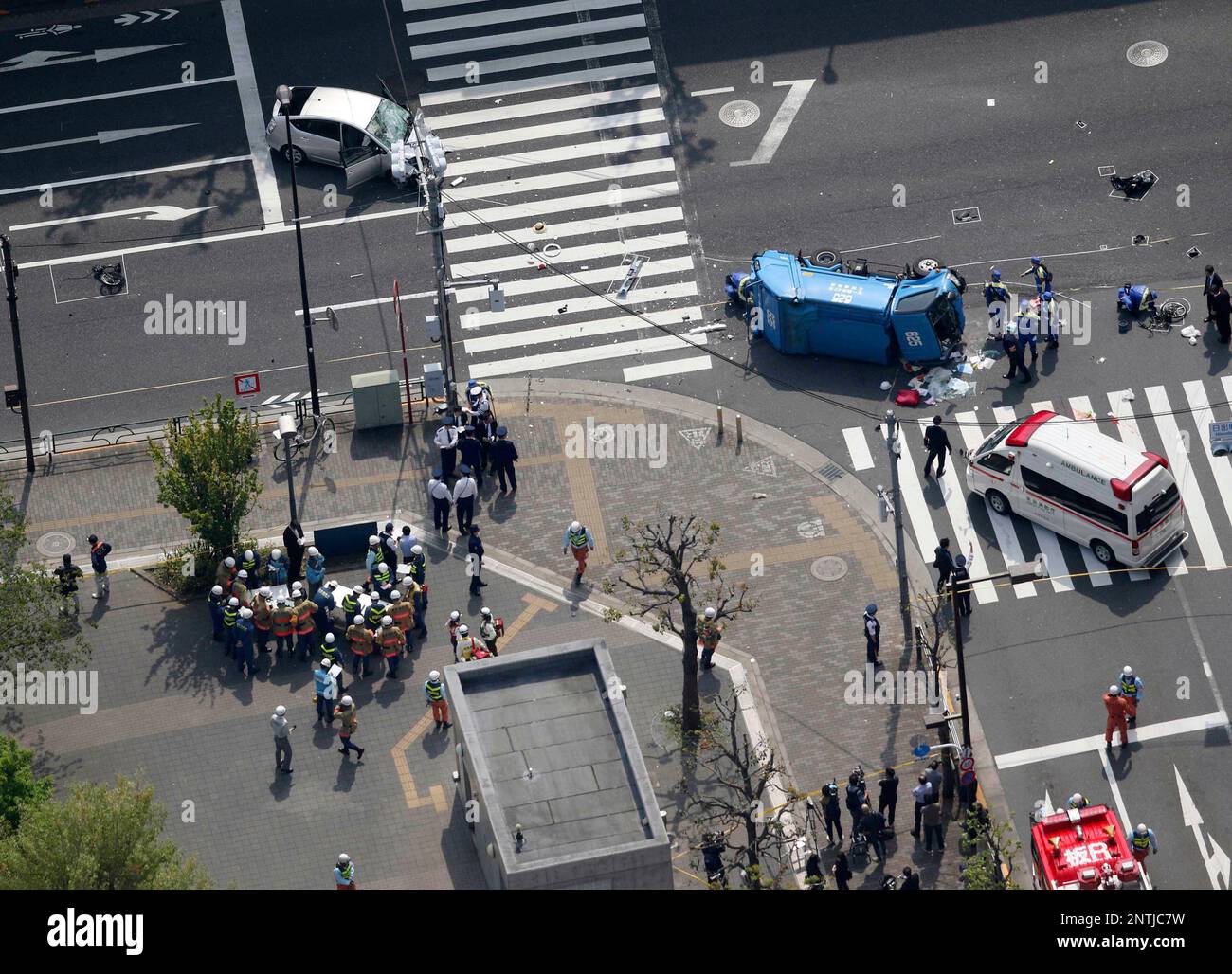 Police officers inspect the scene of a car accident in Tokyo Friday ...