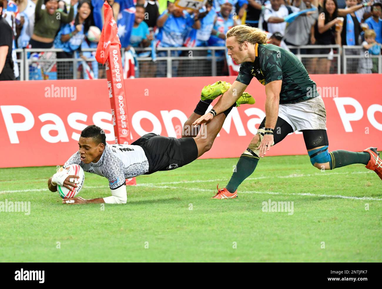 Fiji's Napolini Bolaca dives over to score with South Africa's Werner ...