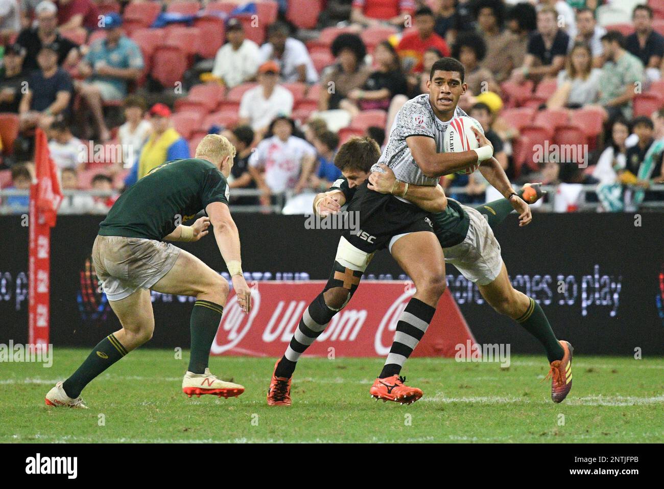 Fiji's Meli Derenalagi is tackled by South Africa's Chris Dry during ...