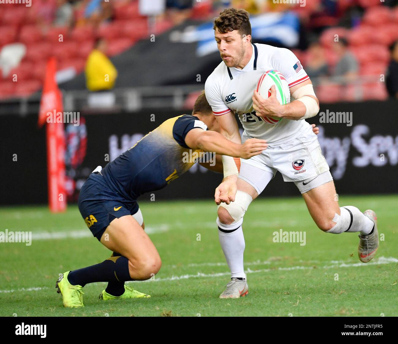 USA's Stephen Tomasin drives at the Argentine defence during the HSBC ...